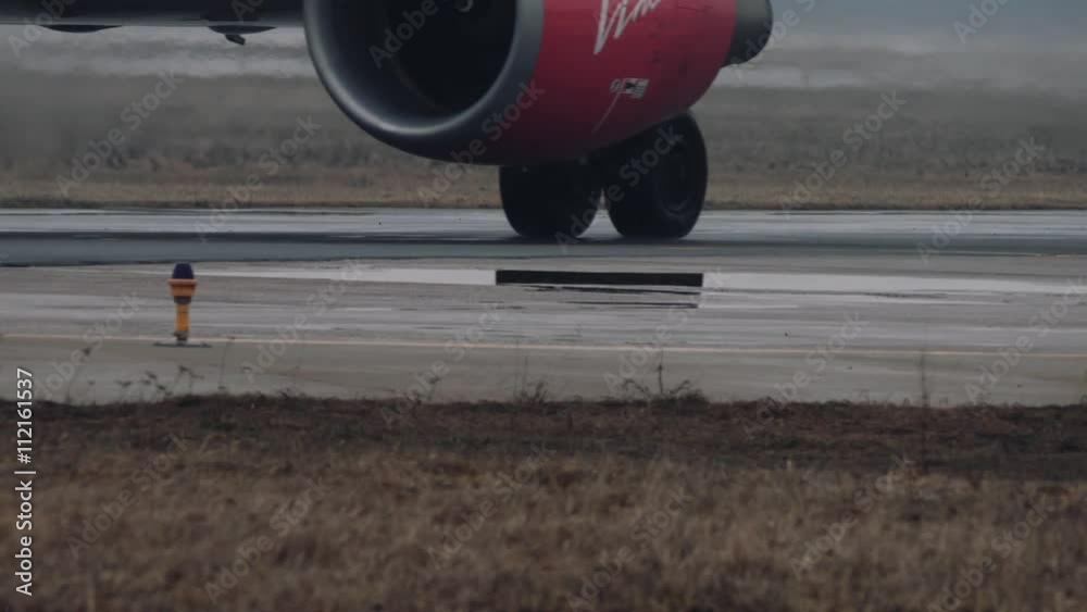Wheels and turbines of an airbus a320 moving on a runway in the airport ...
