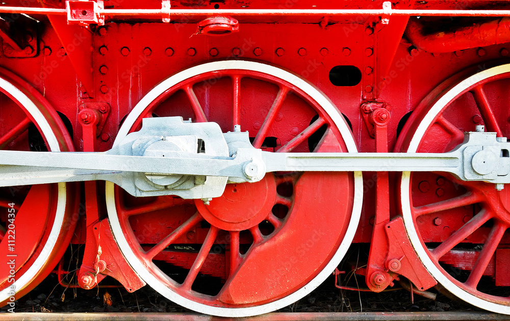 Detail of the wheels of a steam locomotive. Red wheels of an old steam ...