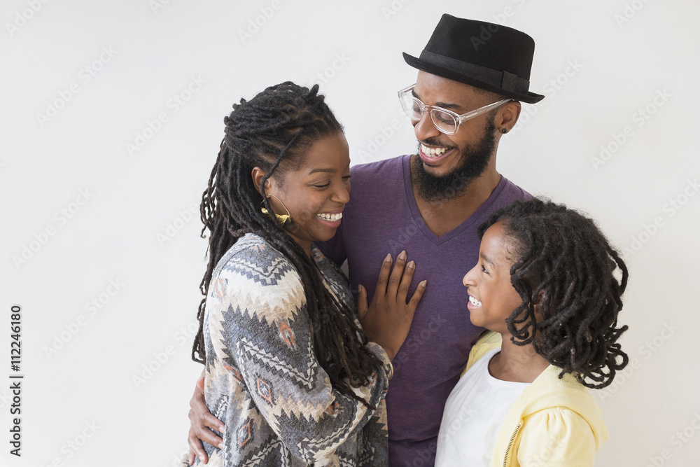 Smiling Black family hugging Stock Photo | Adobe Stock