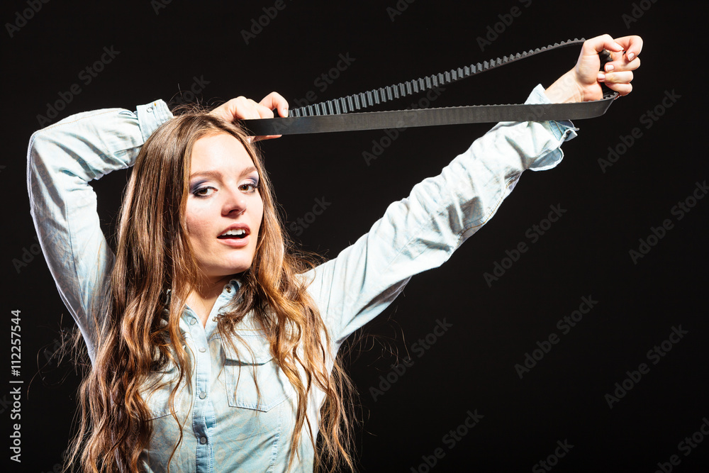 Sexy alluring woman holding fan belt. Feminism. Stock Photo | Adobe Stock