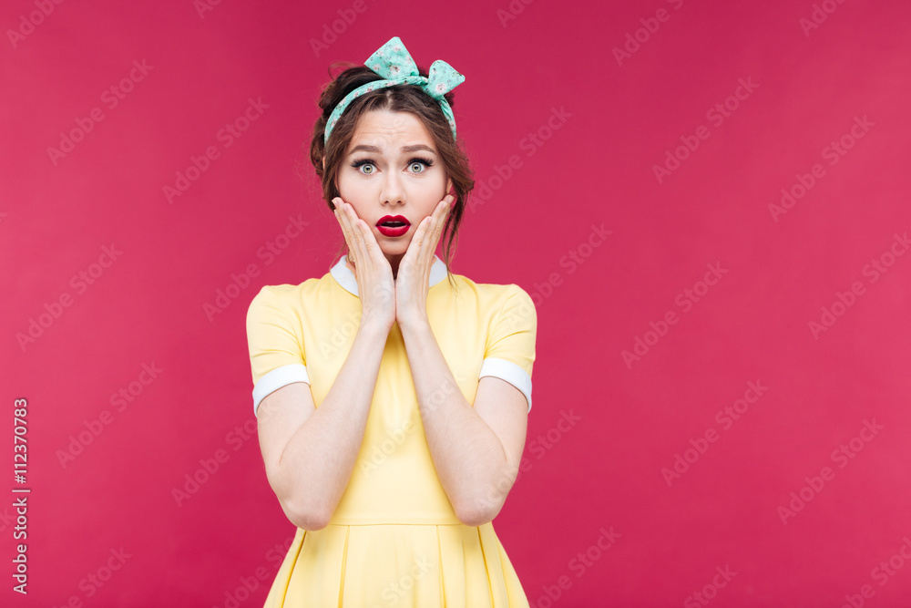 Sad shocked pinup girl in yellow dress Stock Photo | Adobe Stock