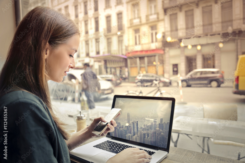 Woman at the cafe using technological devices Stock Photo | Adobe Stock
