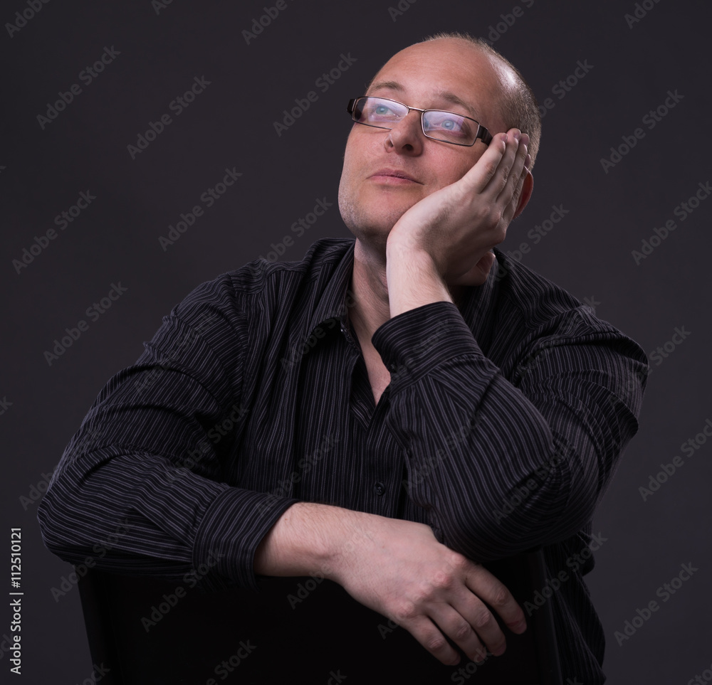 bored caucasian guy sitting on a chair Stock Photo | Adobe Stock