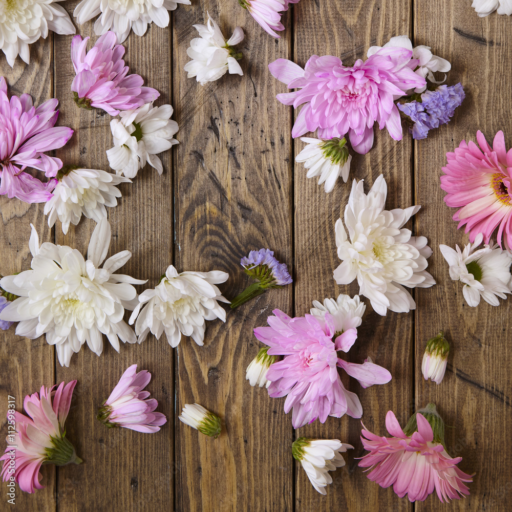 Flower heads scattered on a wooden background Stock Photo | Adobe Stock