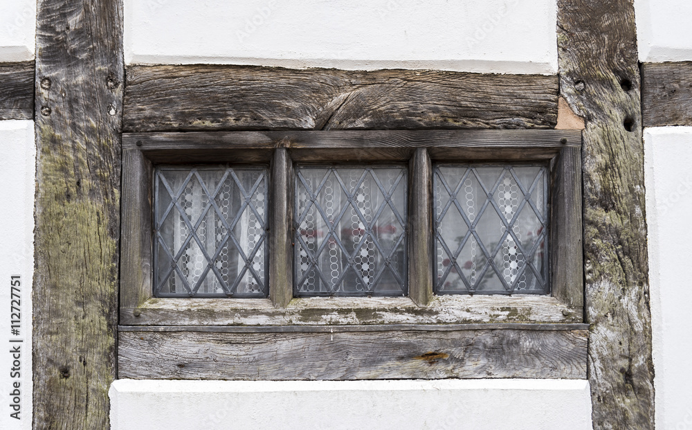 Traditional Tudor style window frame, with wooden beams surrounding the ...