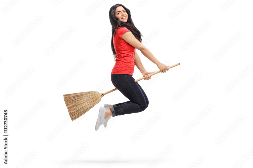 Young woman flying on a broom Stock-Foto | Adobe Stock