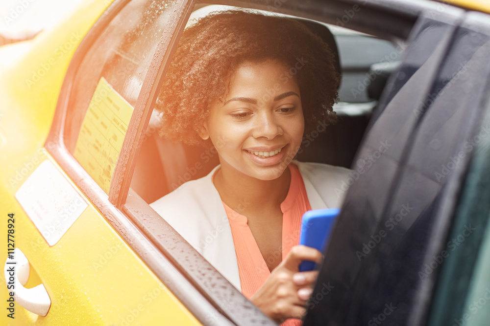 happy african woman texing on smartphone in taxi Stock Photo | Adobe Stock