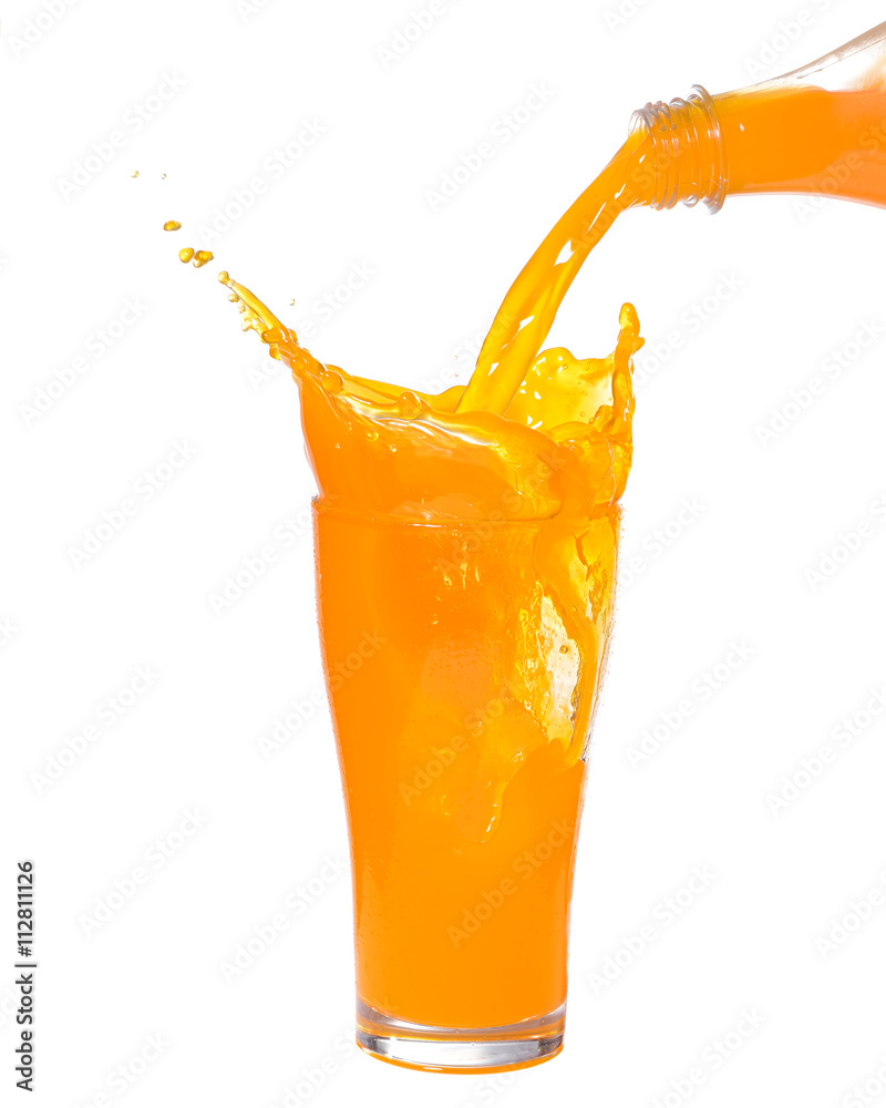 Pouring orange juice from bottle into glass with splashing., Isolated ...