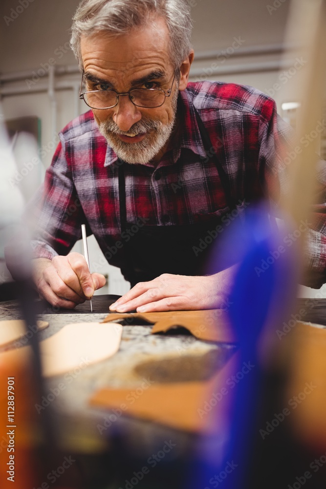 Focus on background of cobbler drawing shoes Stock Photo | Adobe Stock