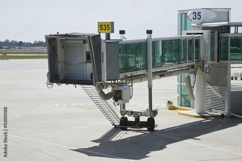 Passenger boarding bridge at an airport Stock Photo | Adobe Stock