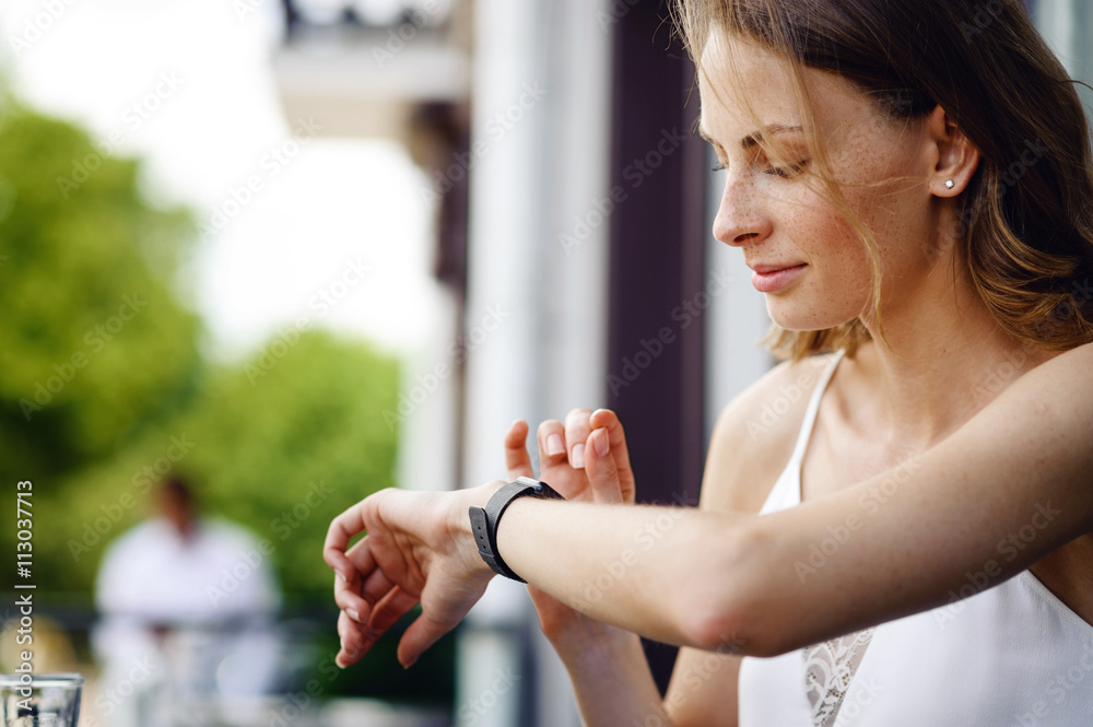 Young girl checks the time on their smart watches Stock Photo | Adobe Stock