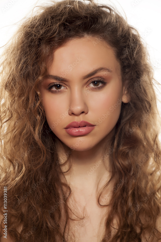 Fotografia do Stock: skeptical beautiful young woman with a raised ...