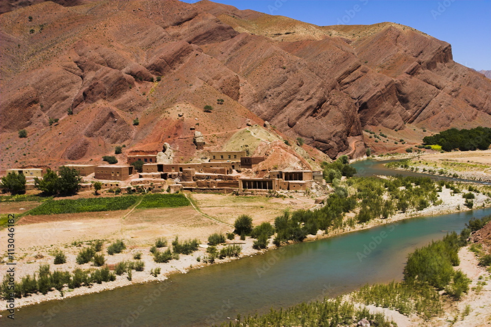 Hari Rud river flows through fertile valley at base of red rock ...