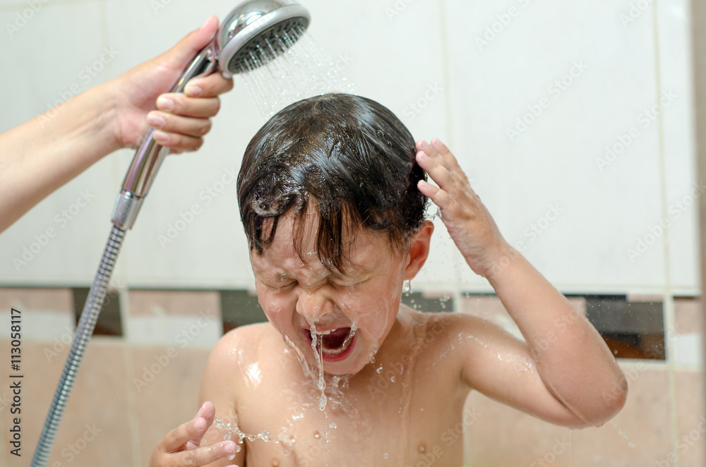 Boy washing hair with shampoo Stock Photo | Adobe Stock