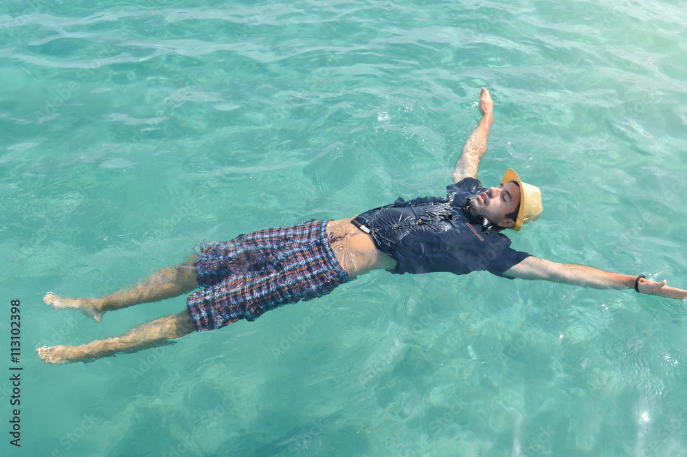man floating on the water. Summer relaxation Stock Photo | Adobe Stock