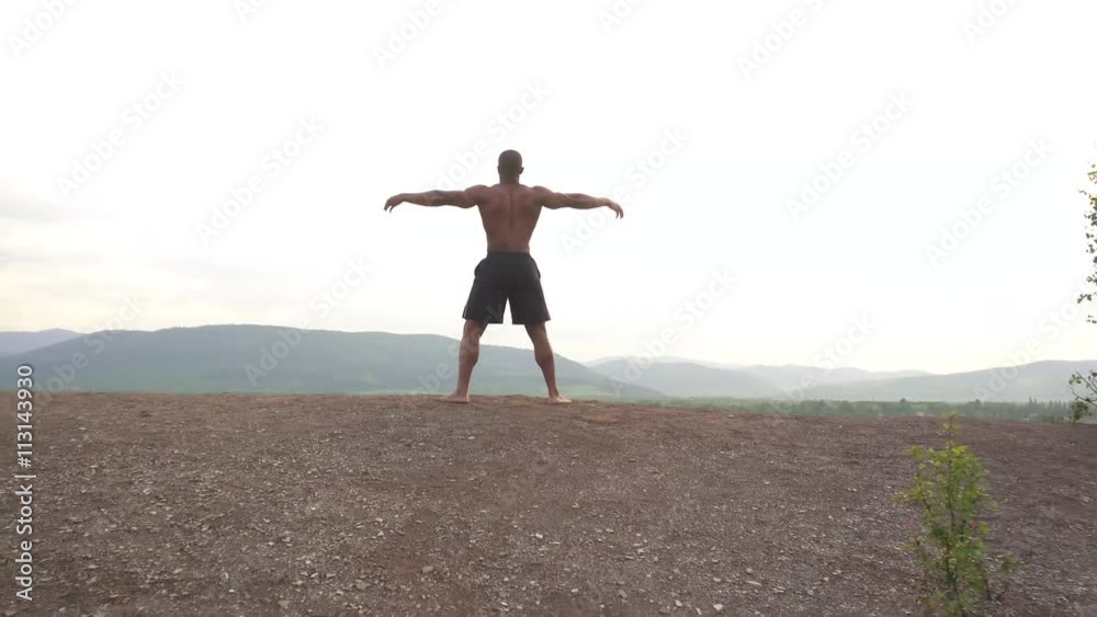 Breathtaking moment of african american body builder stretching on the ...