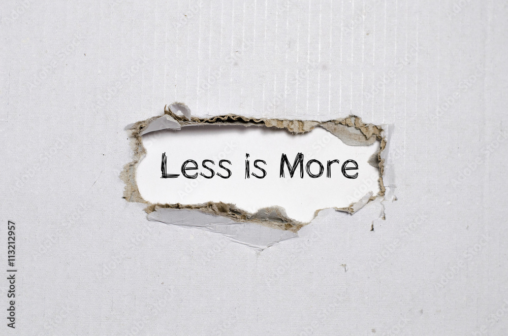 Photo & Art Print The word less is more appearing behind torn paper ...