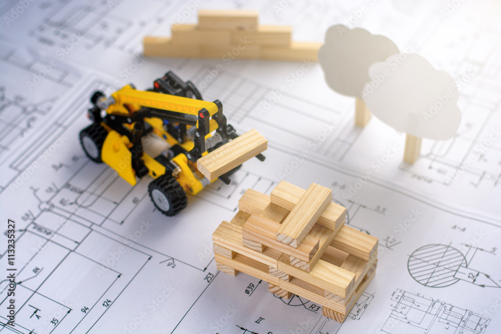 Toy construction machine buildsmodel of house from wooden blocks (bars ...