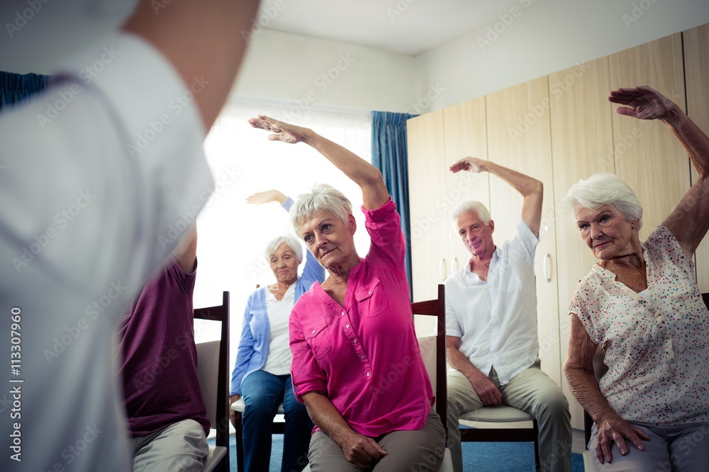 Group of seniors doing exercises with nurse Stock Photo | Adobe Stock