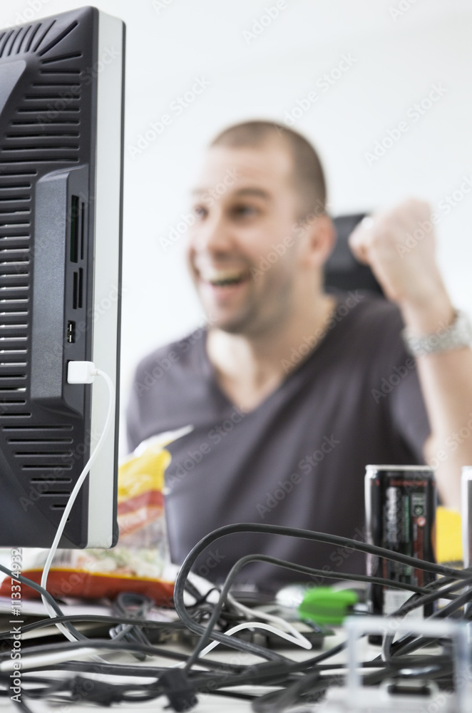 Man cheering behind the computer screen Stock Photo | Adobe Stock