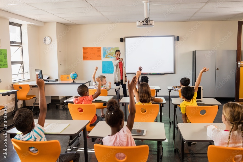 Teacher giving lesson to her students Stock Photo | Adobe Stock