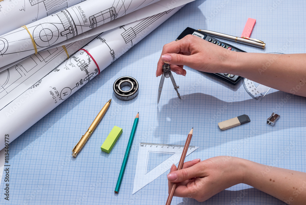 Using engineer compass on graph paper with engineering drawing and ...