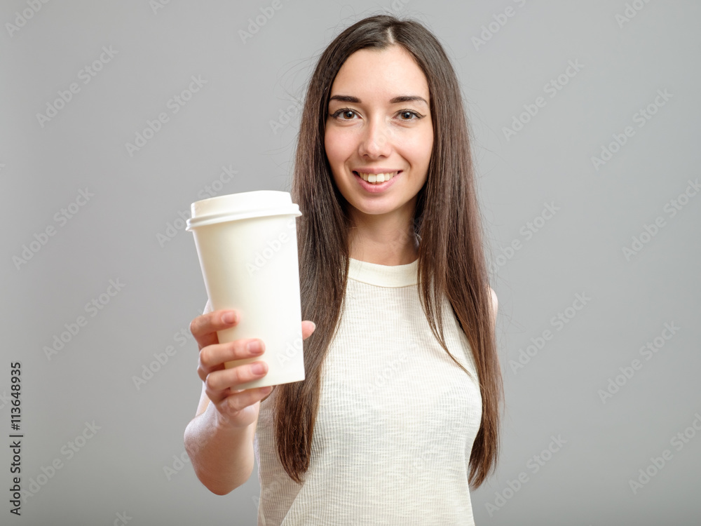 Woman offering white cup of coffee Stock Photo | Adobe Stock