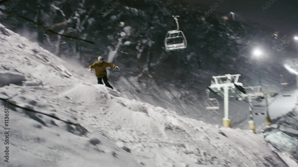 Snowboarder Does a Method Air Trick Grabbing His Board While Night ...