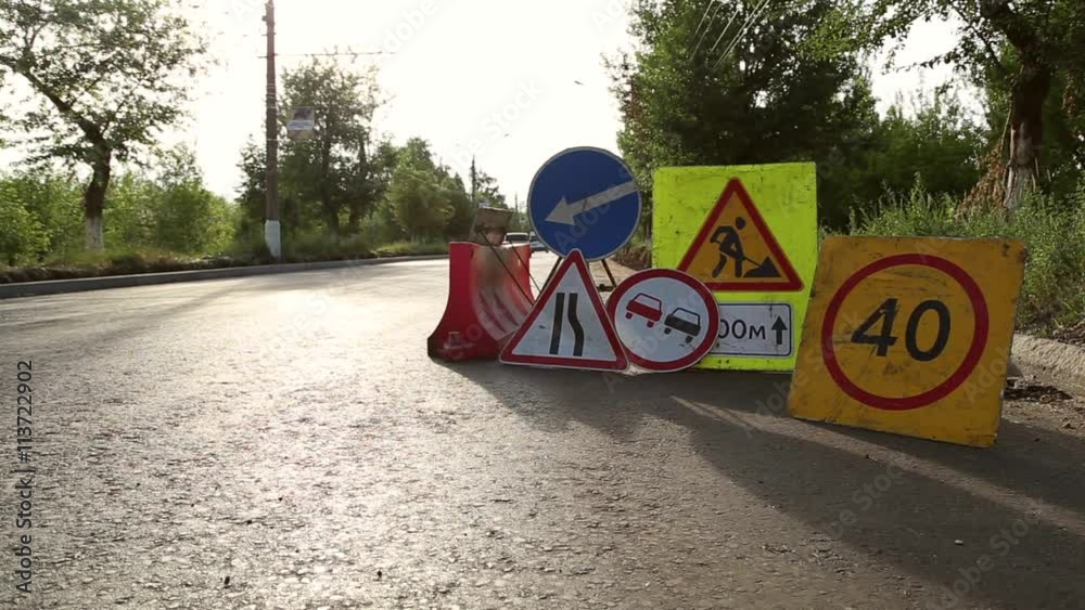 Traffic signs installed in the pile, during road repair, past rides ...