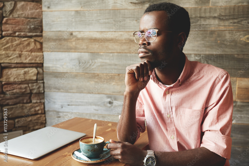 Portrait of successful young African American journalist drinking ...