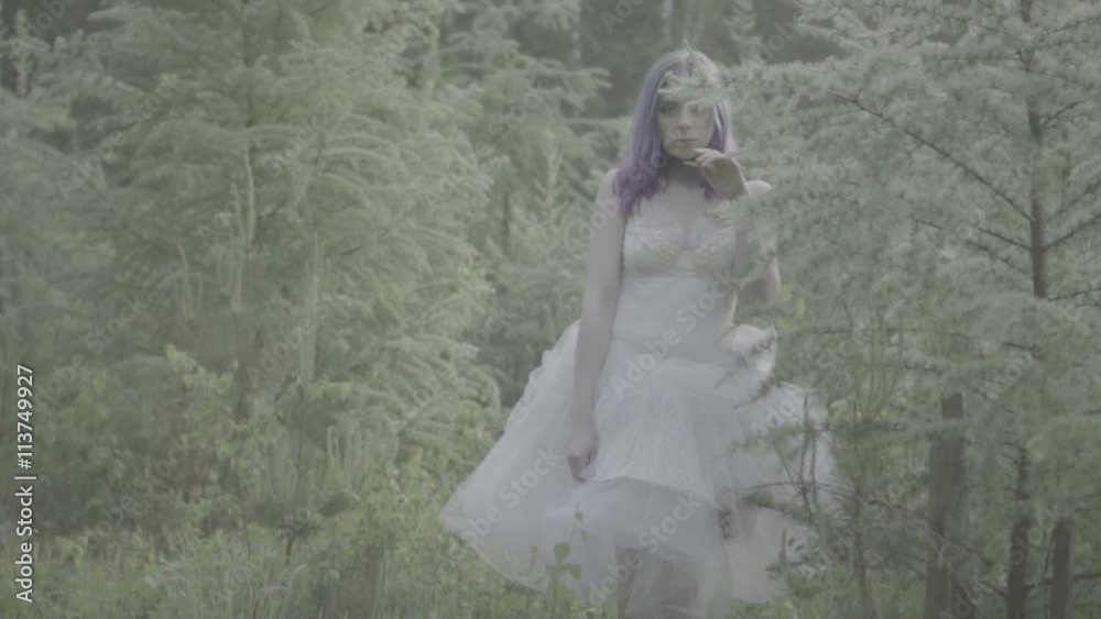Beautiful woman in white dress and purple hair falling down on the ...