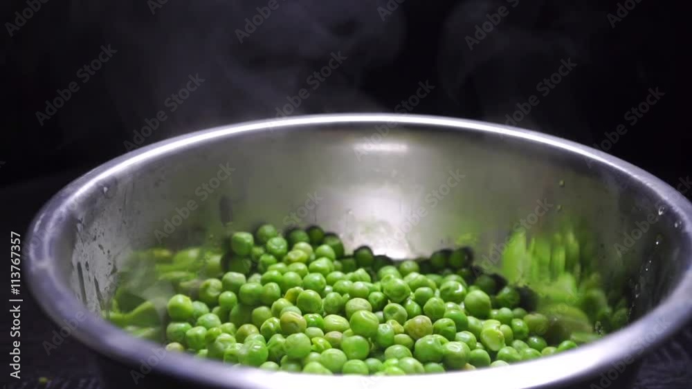 Steel bowl of steaming boiled green peas Stock Video | Adobe Stock