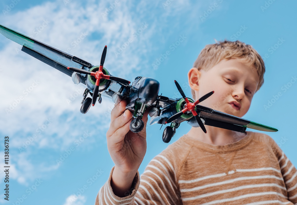 Boy play with toy plane Stock Photo | Adobe Stock