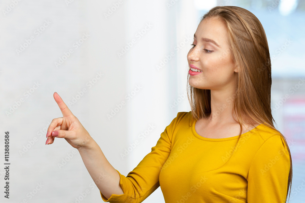 smiling young woman pointing Stock Photo | Adobe Stock
