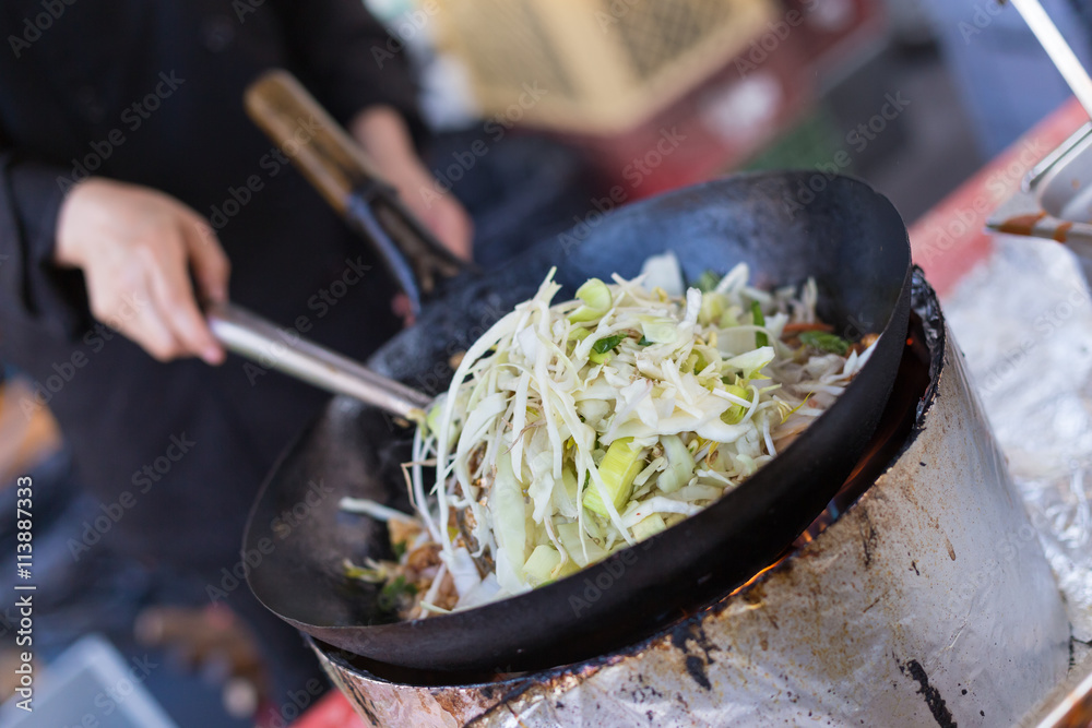 Cheff cooking traditional Thai noodles, Pad Thai, on street stall on ...