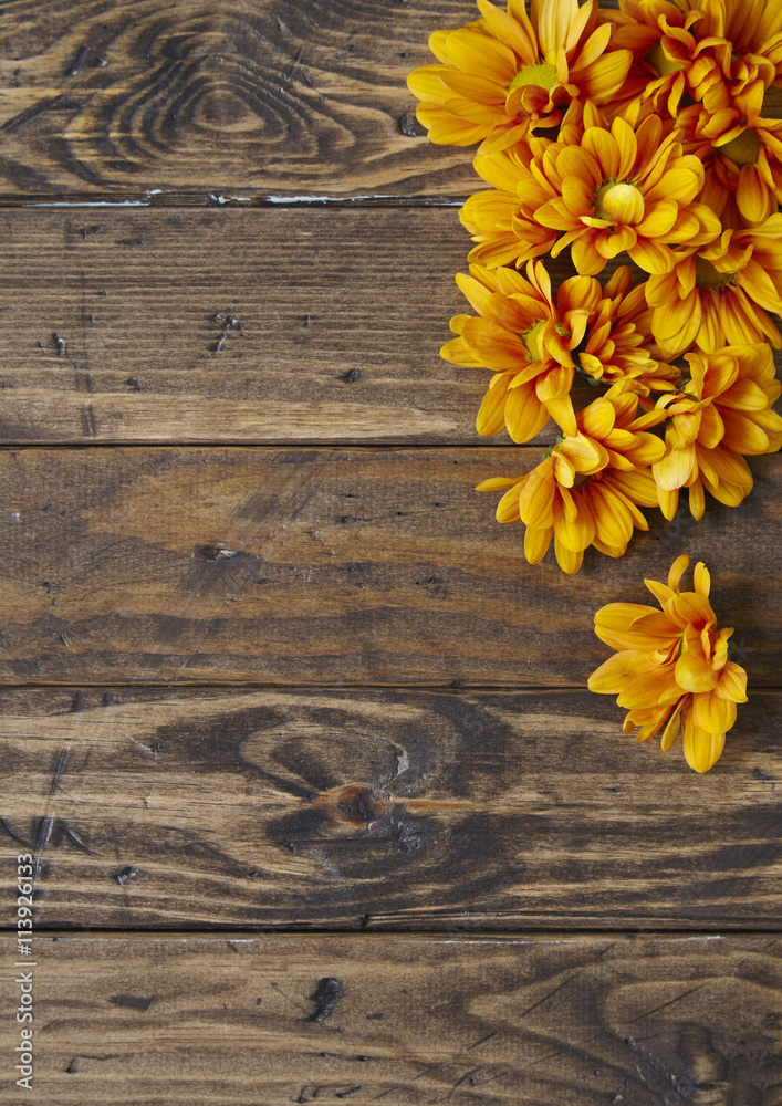 Floral border - Orange flowers arranged on a rustic, distressed wood ...