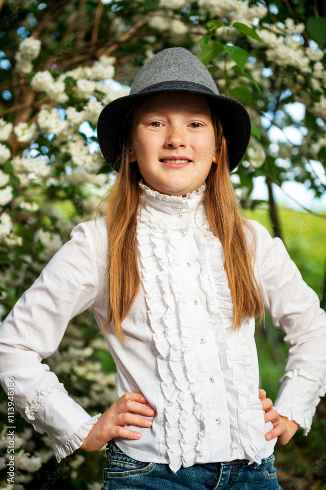 Portrait of pretty little girl of 8-9 years old in garden. Kid girl ...