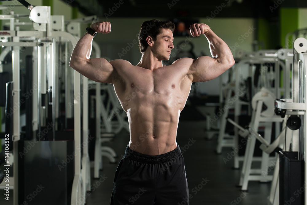 Bodybuilder Performing Front Double Biceps Pose In Gym Stock Photo ...
