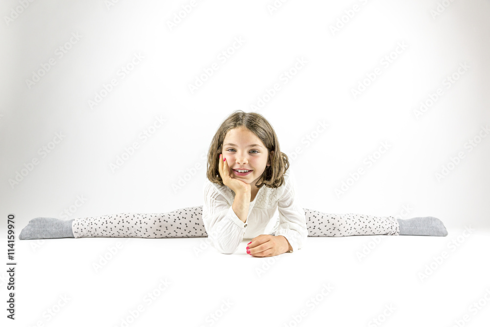 Cute fit athletic girl leans forward in splits on floor, studio shot ...