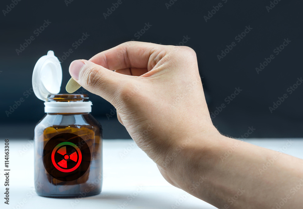 Toxic sign on tablets bottle with hand holding tablet Stock Photo ...