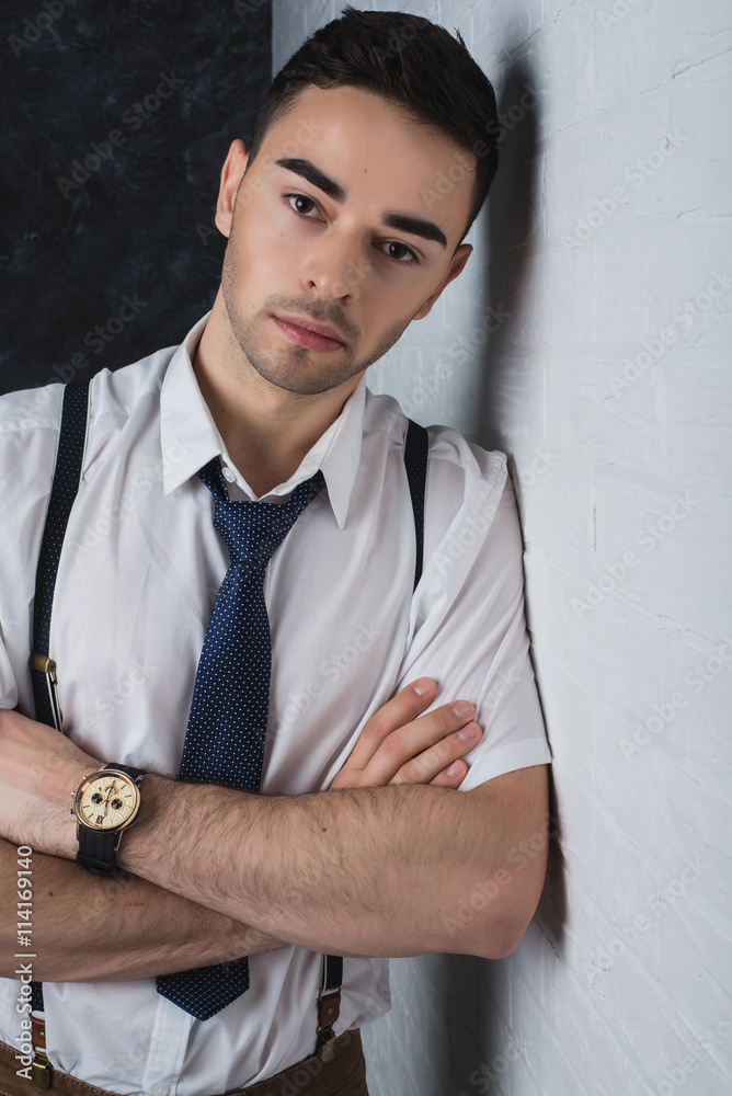 Portrait of a smart young man standing against white background Stock ...