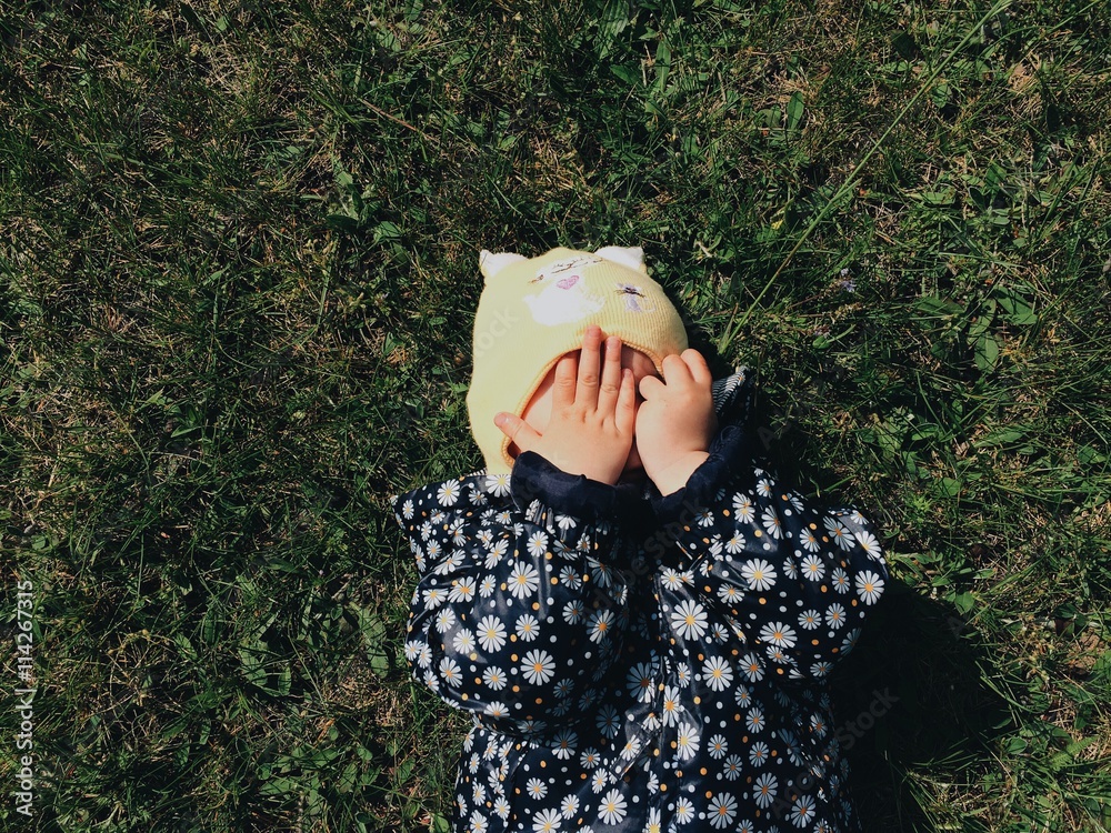 funny baby kid covered her face with his hands Stock Photo | Adobe Stock