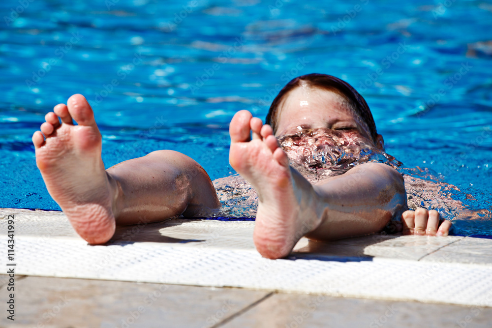 Children's feet in a spray of water in the pool Stock Photo | Adobe Stock