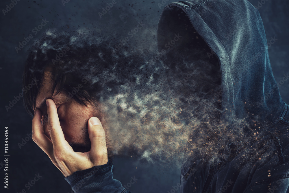 Hooded man taking off his face mask Stock Photo | Adobe Stock