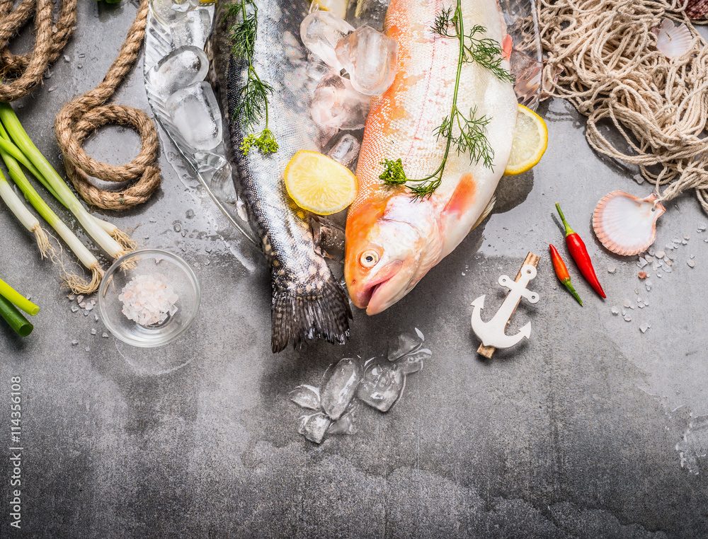 Fresh raw whole fish with ingredients for tasty and healthy cooking on ...