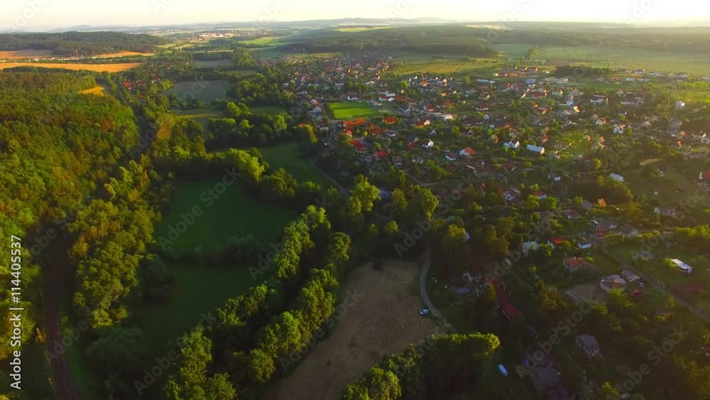 Camera flight over Czech countryside at sunset. Forest, fields, meadows ...