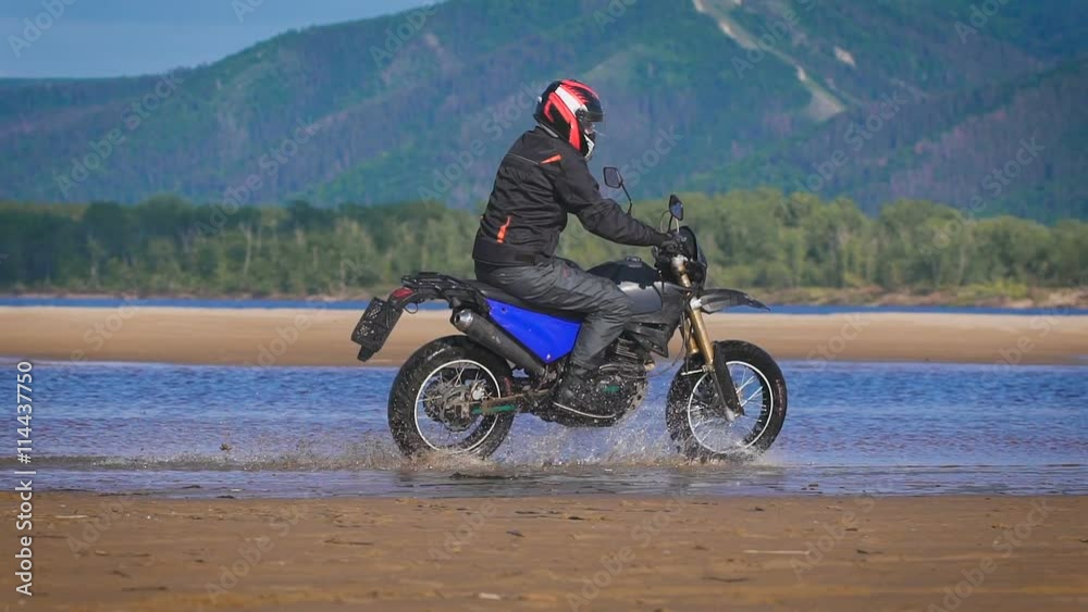 Extreme driving a motorcycle. A skilled biker riding on the edge of ...