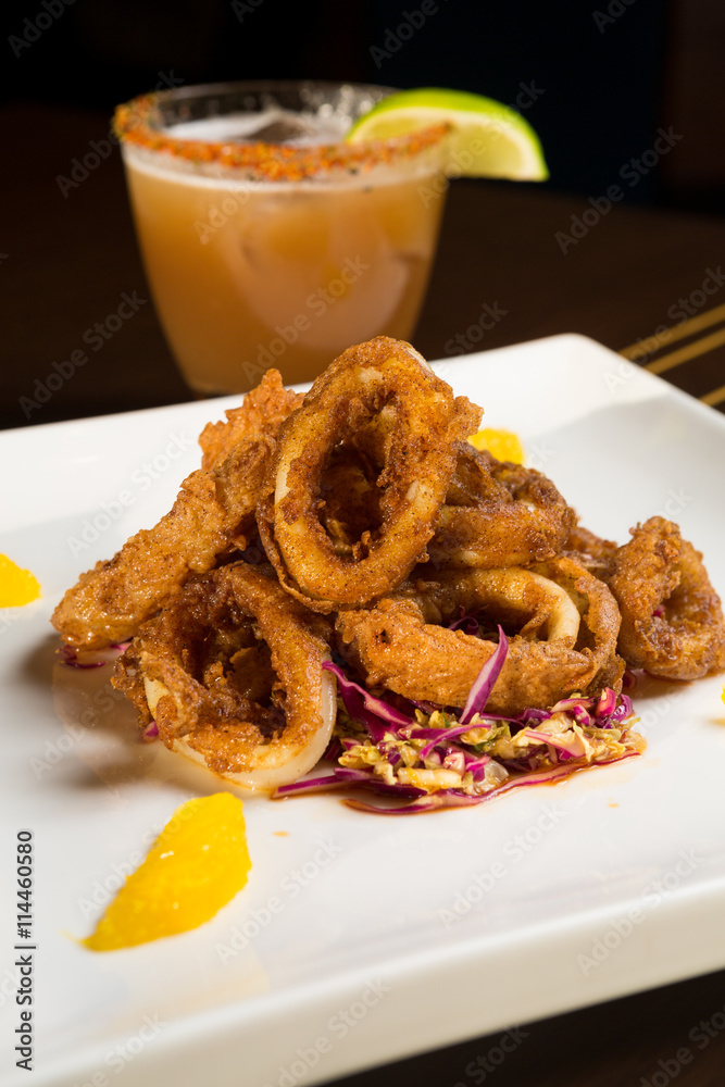 Beautiful golden crispy deep fried calamari rings, served on a white ...