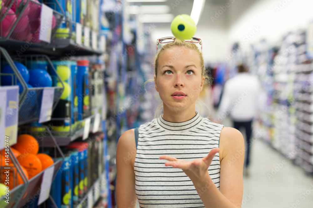 Beautiful caucasian woman shopping sports equipment in sportswear store ...