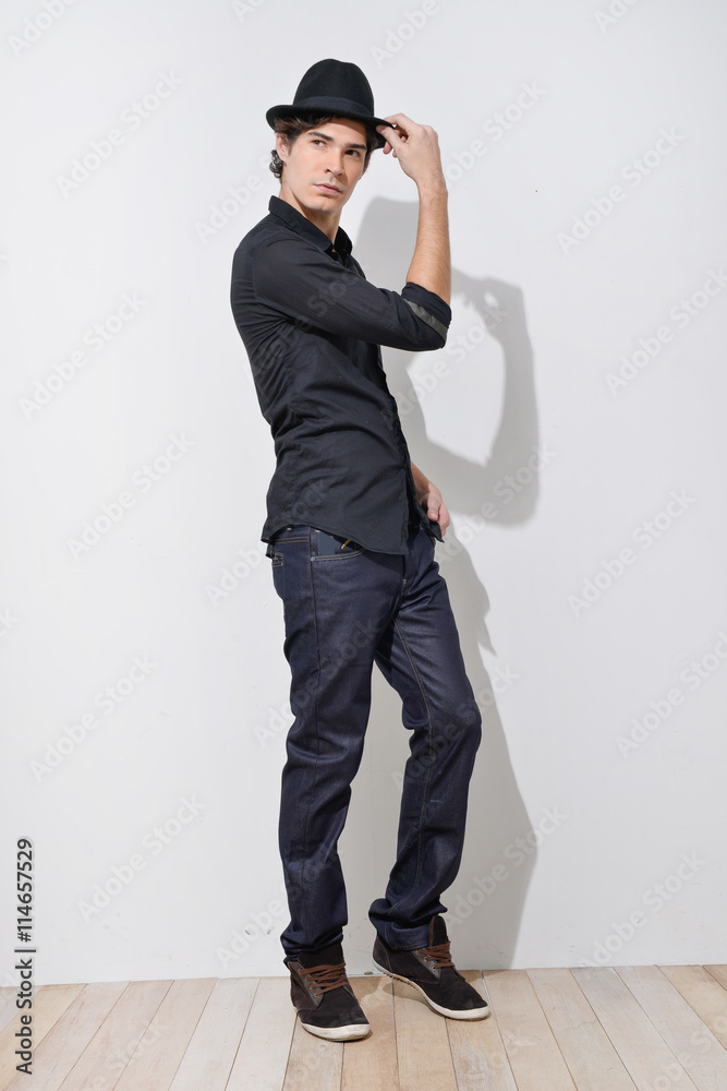 Full body Young mal model in jeans with hat posing in the studio Stock ...